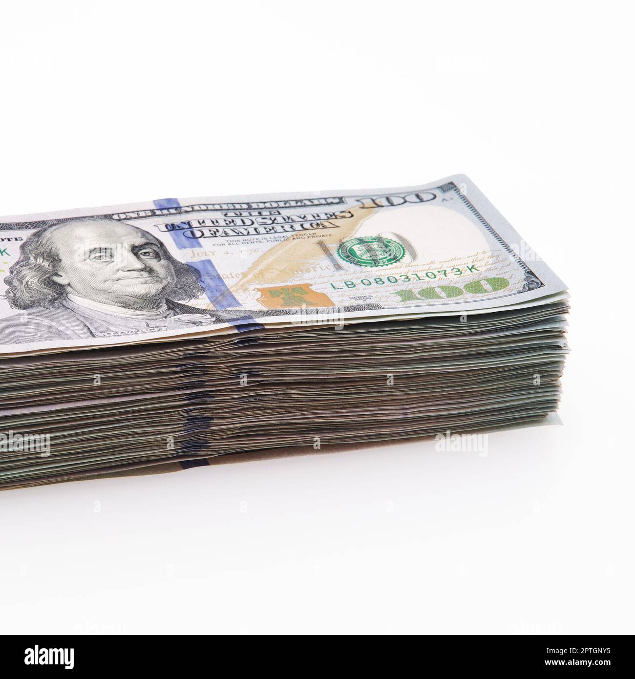 A large stack of hundred-dollar cash bills on a white background ...