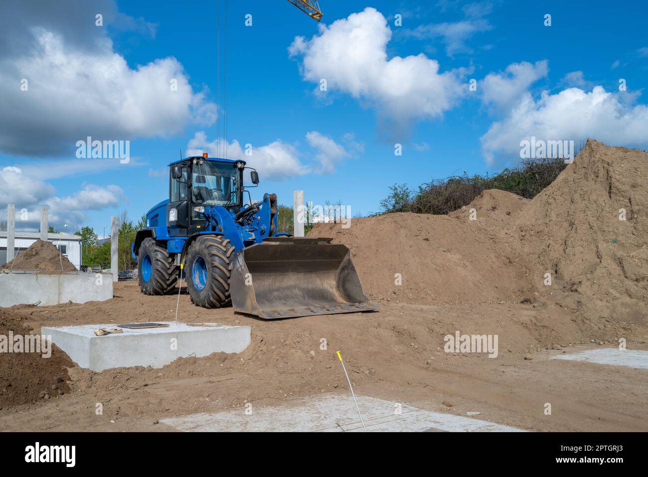 a big blue wheel loader stands on a construction site Stock Photo - Alamy