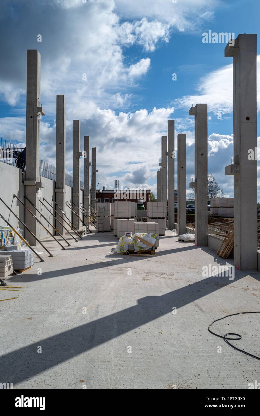 many concrete pillars for a factory building are erected on a ...