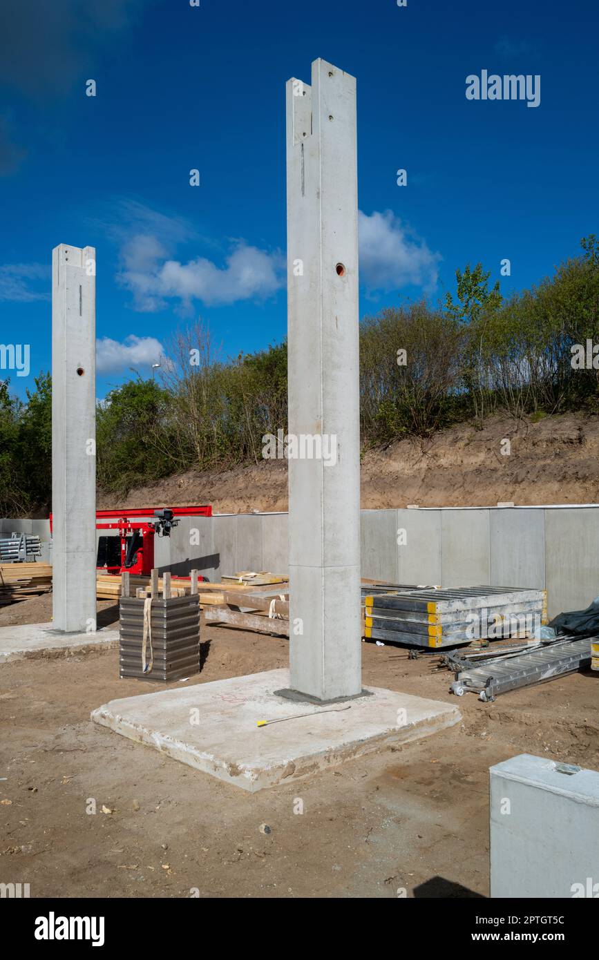 many concrete pillars for a factory building are erected on a ...