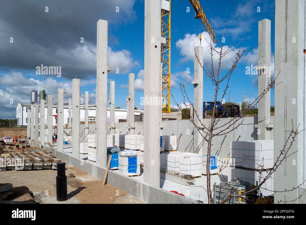 many concrete pillars for a factory building are erected on a ...