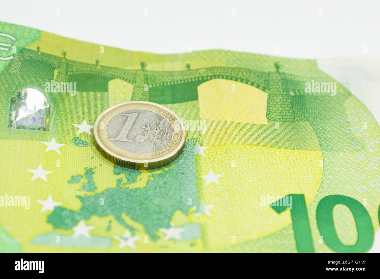 One Euro coin on the hundred Euro note banknote Stock Photo - Alamy