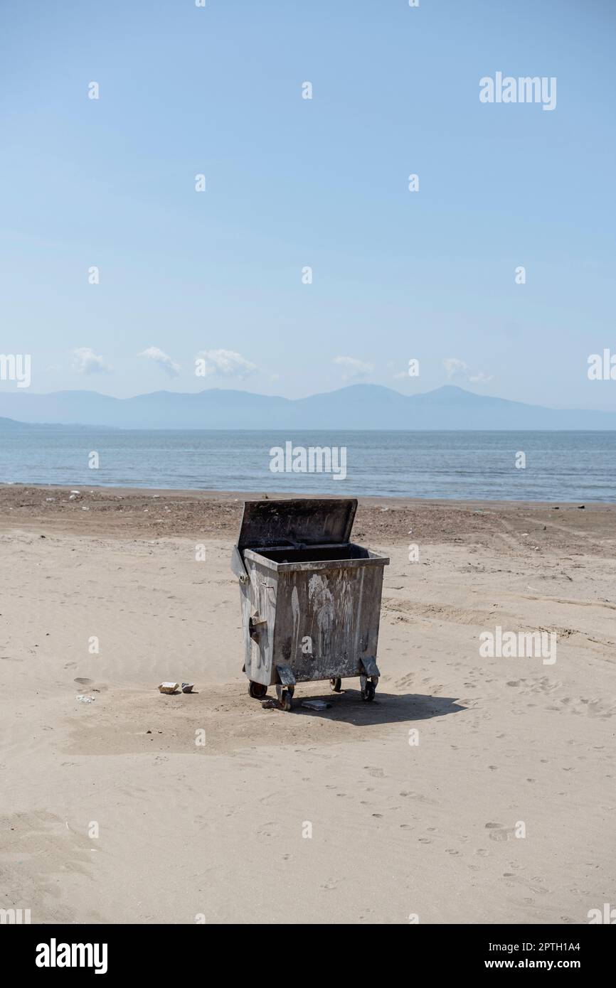 A big metal trash bin on an empty beach Stock Photo - Alamy