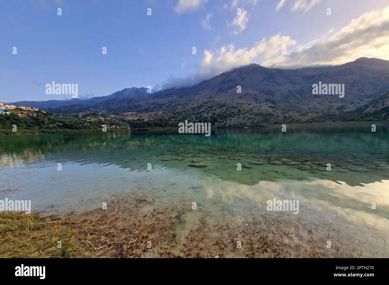 View of beautiful Kournas lake with clear turquoise water during sunset ...
