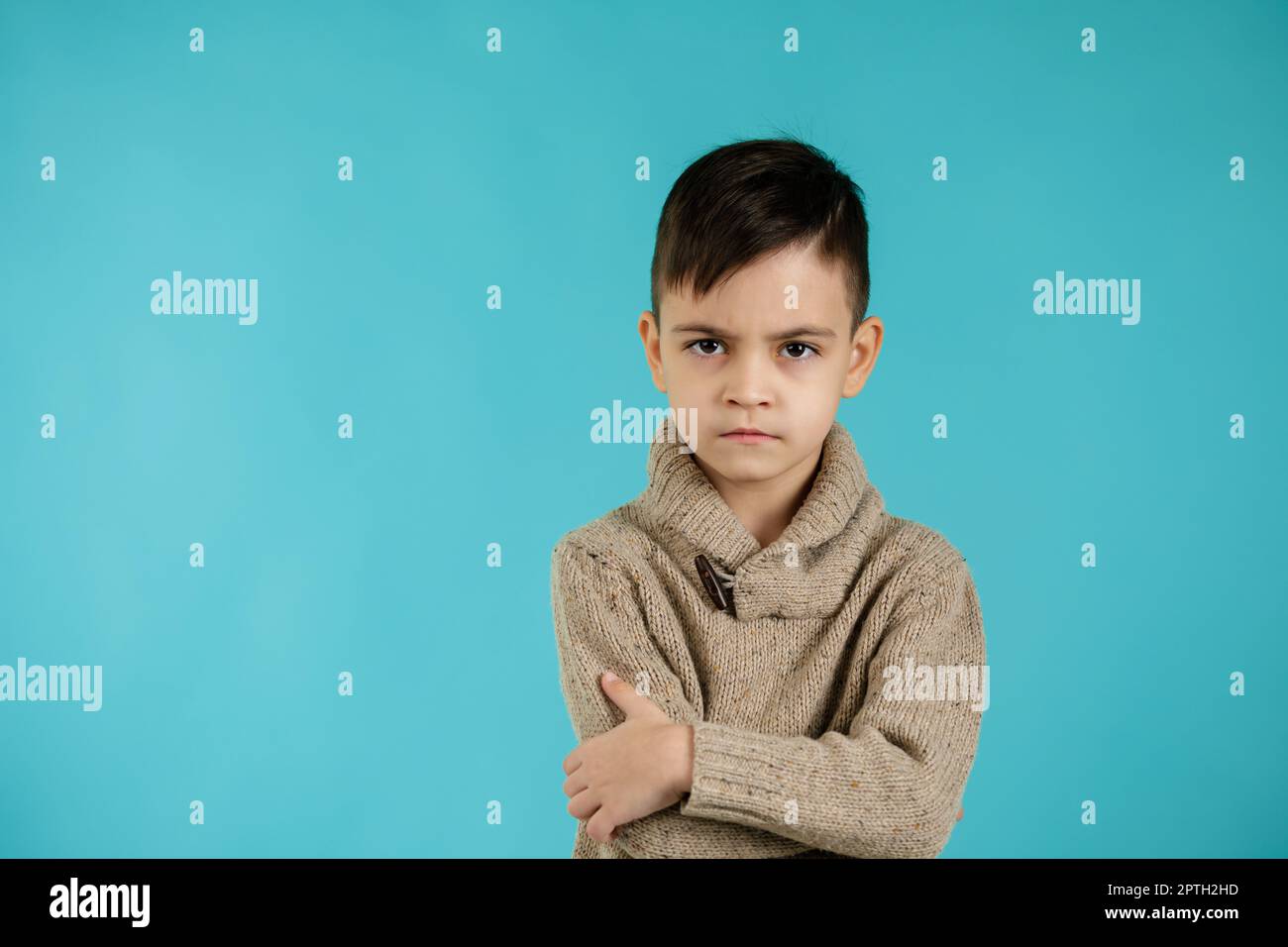 offended sad little child boy on blue background. Human emotions and ...