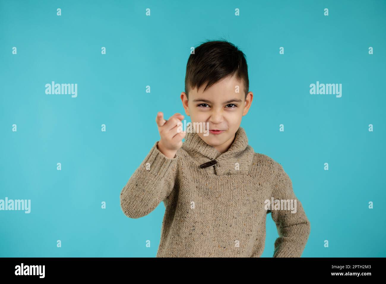 Cute little boy pointing camera on blue background. child pointing at ...