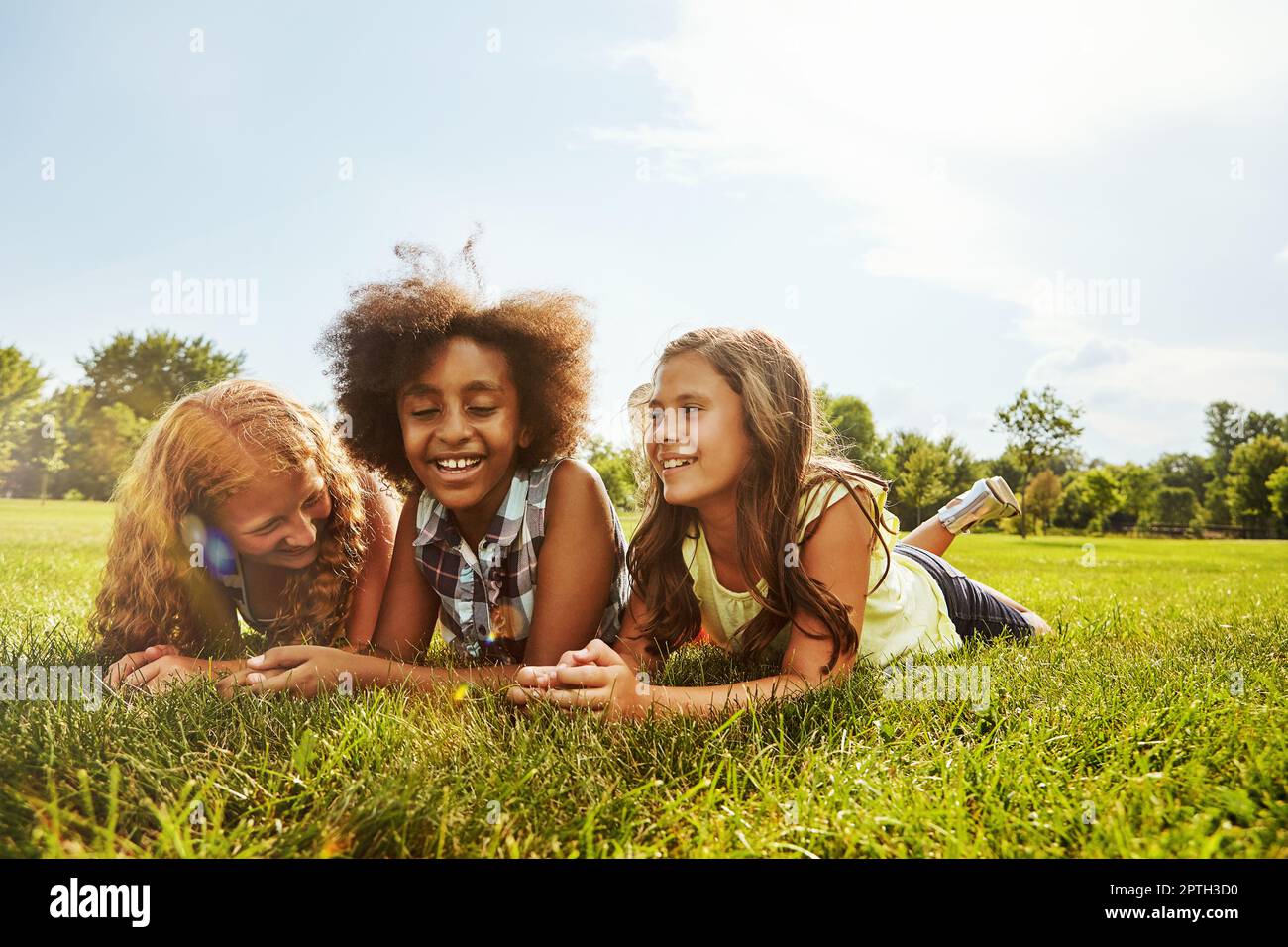 Just some besties bonding together. three young girls lying together on ...