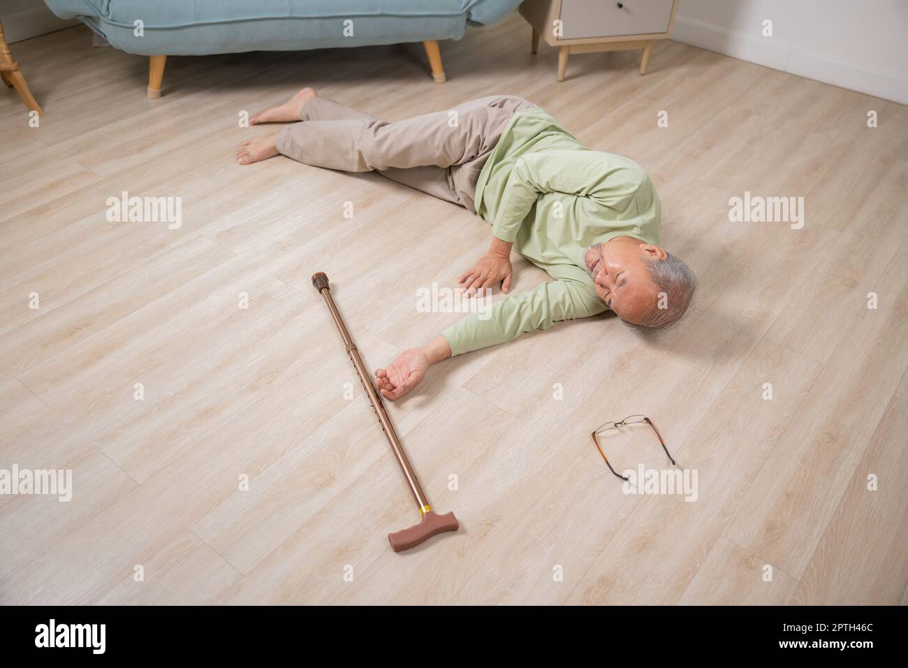 Asian senior man falling down lying on floor at home alone with wooden ...
