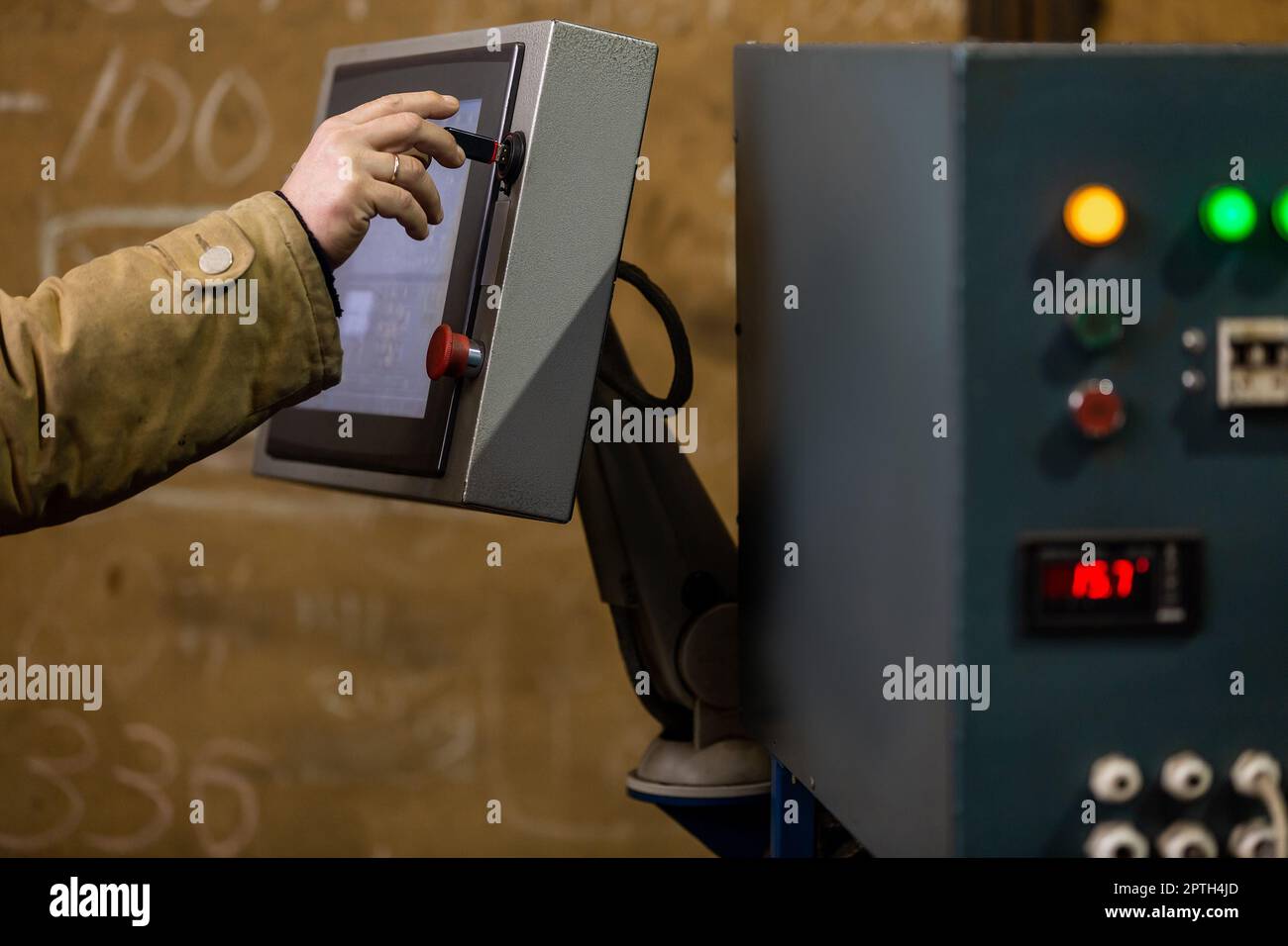 Worker operator using dashboard of CNC machinery or control at machine ...