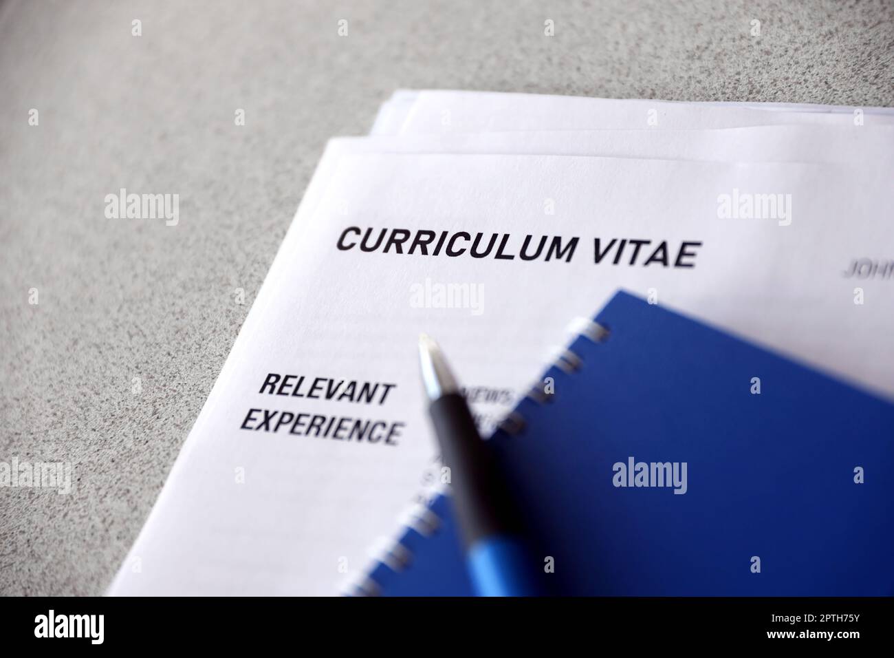 Top view of stack of office documents including resume and cv forms on ...