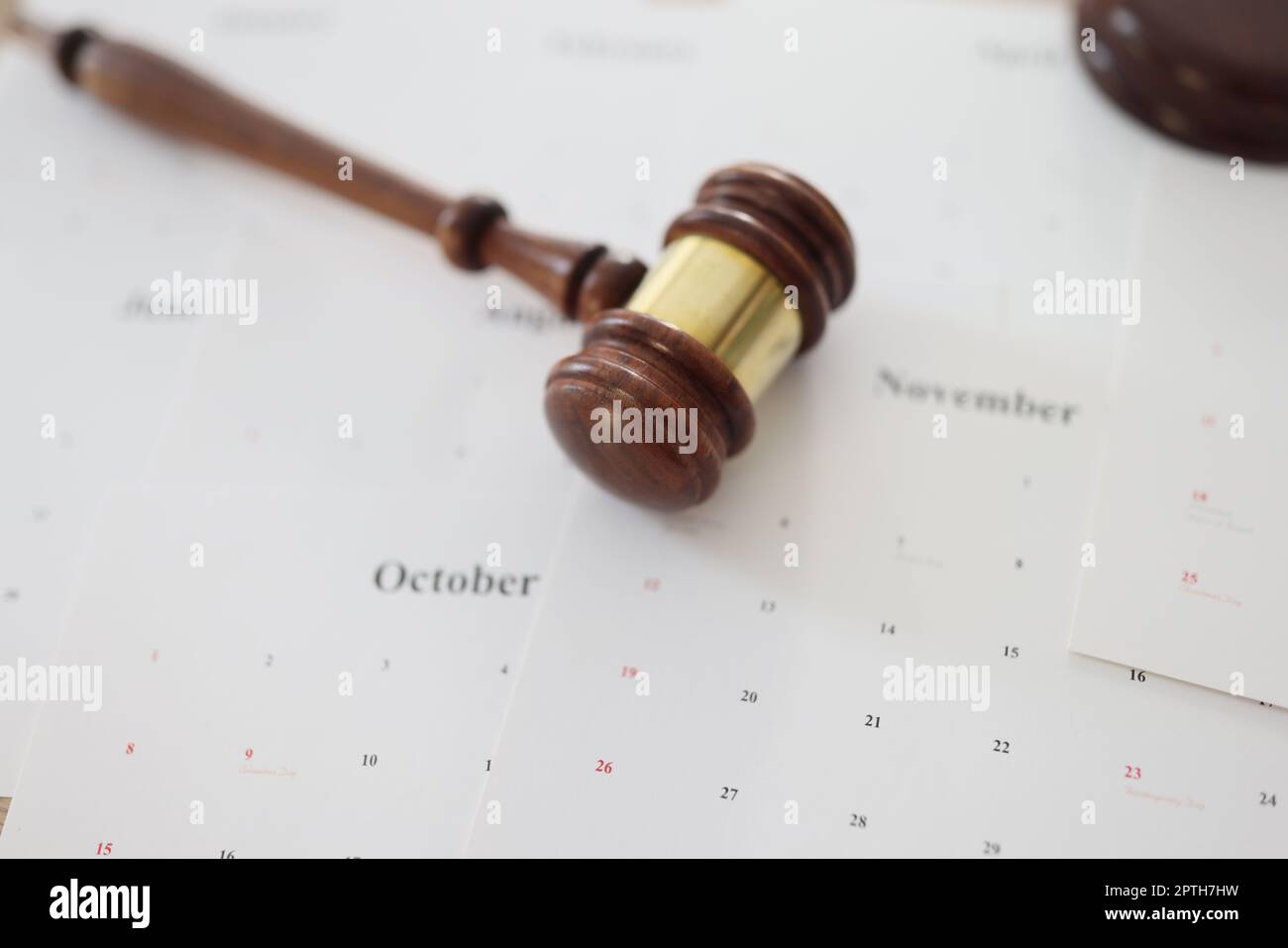 Wooden judge gavel and sound block lie on calendar paper Stock Photo ...