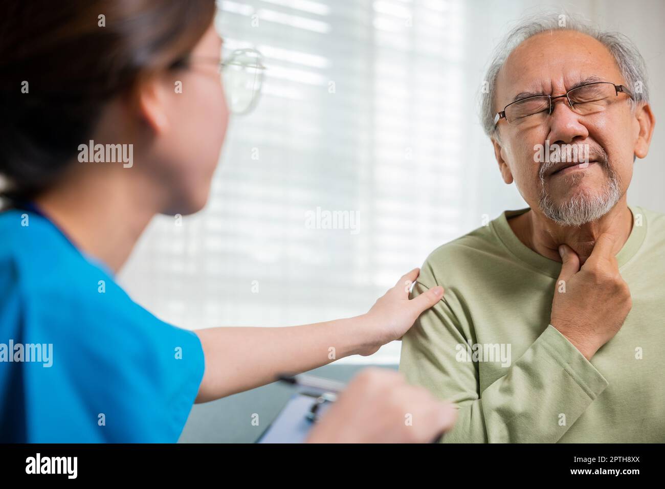 Doctor woman examines lymph nodes on elderly neck to determine if ...