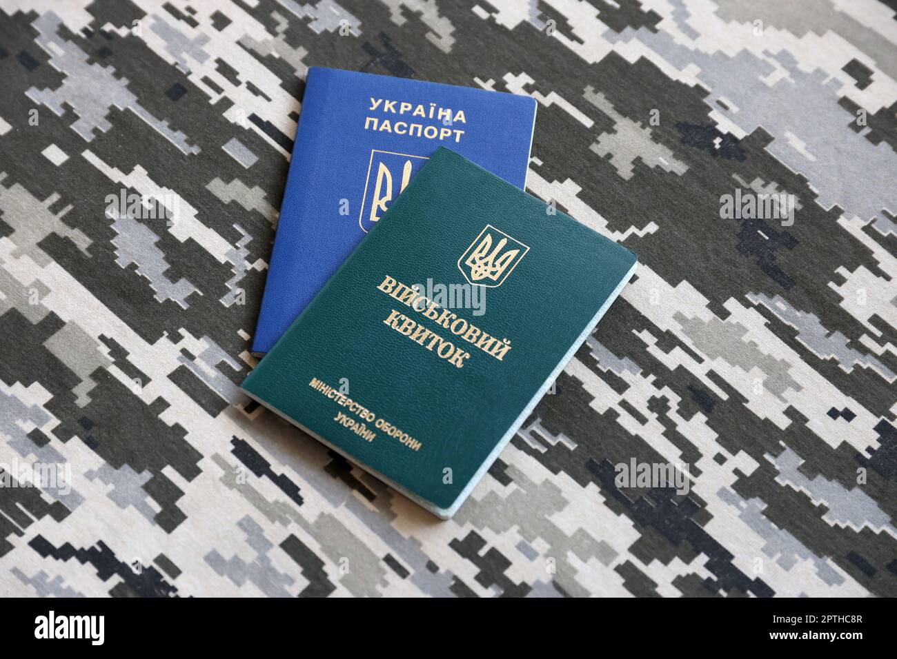 Ukrainian military ID and foreign passport on fabric with texture of ...