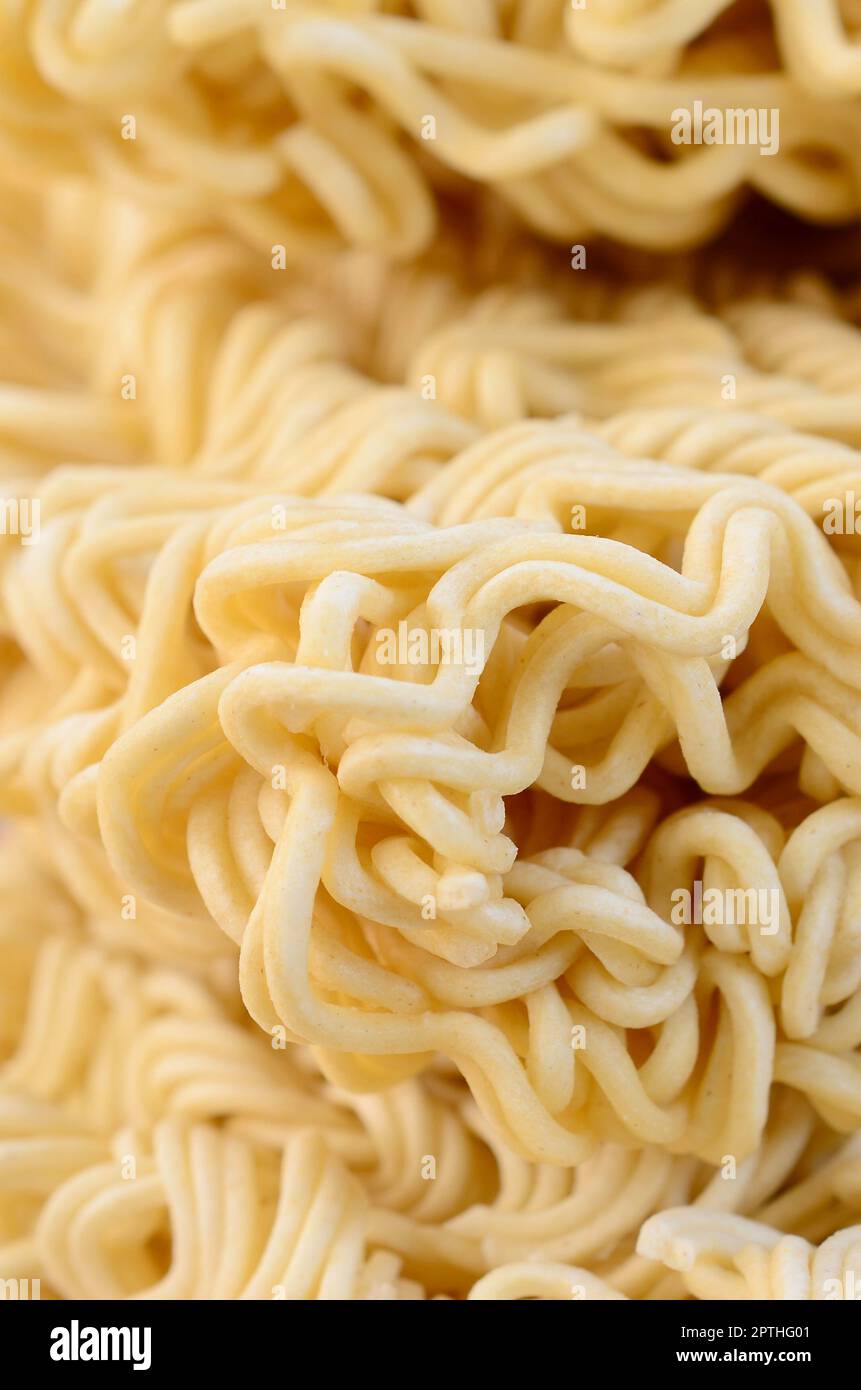 Close up view of yellow dry instant noodles. Chinese traditional food ...