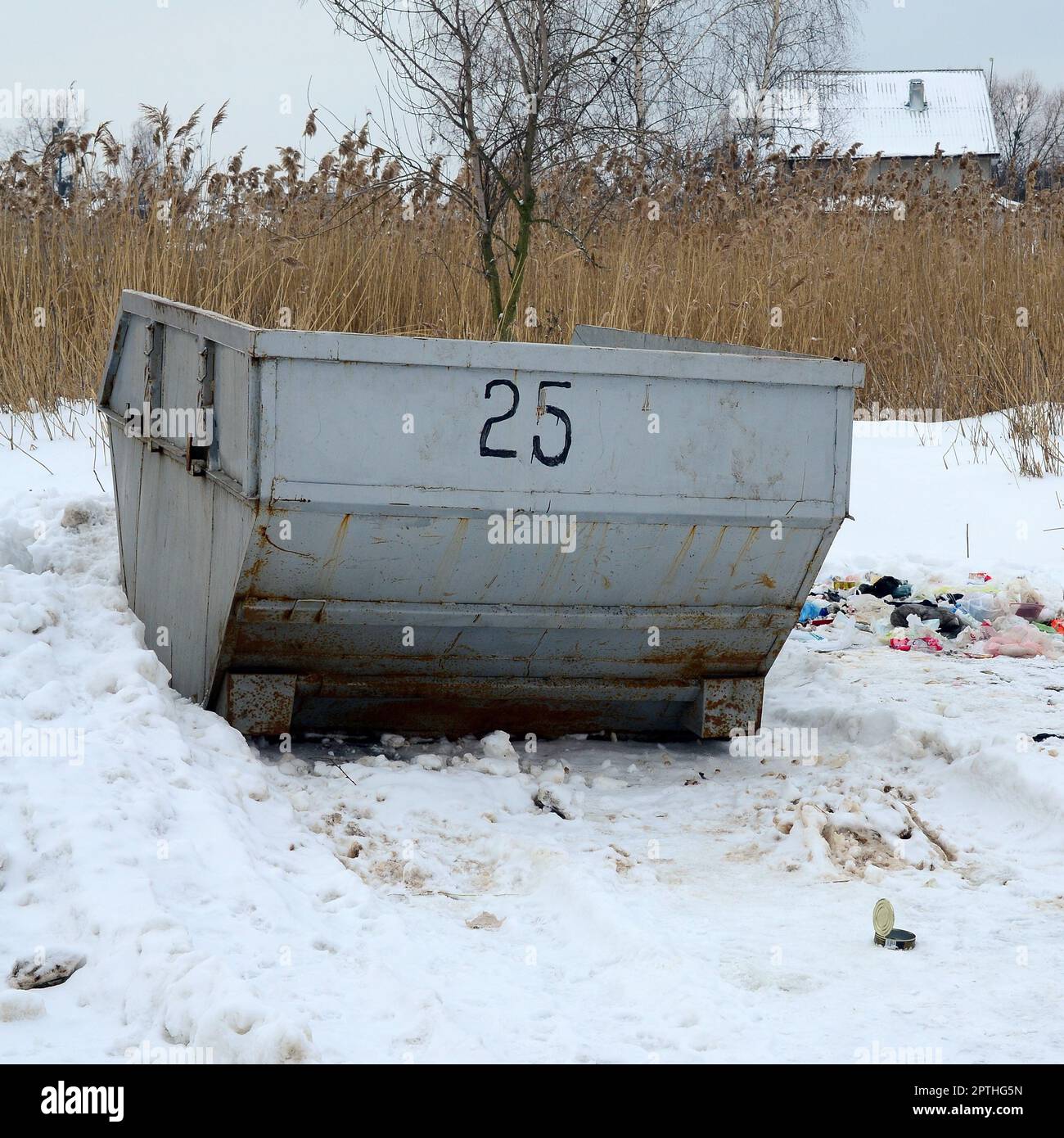 Trash bin at the side of street in winter with lip garbage container ...
