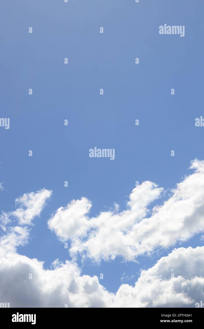 A blue sky with lots of white clouds of different sizes Stock Photo - Alamy