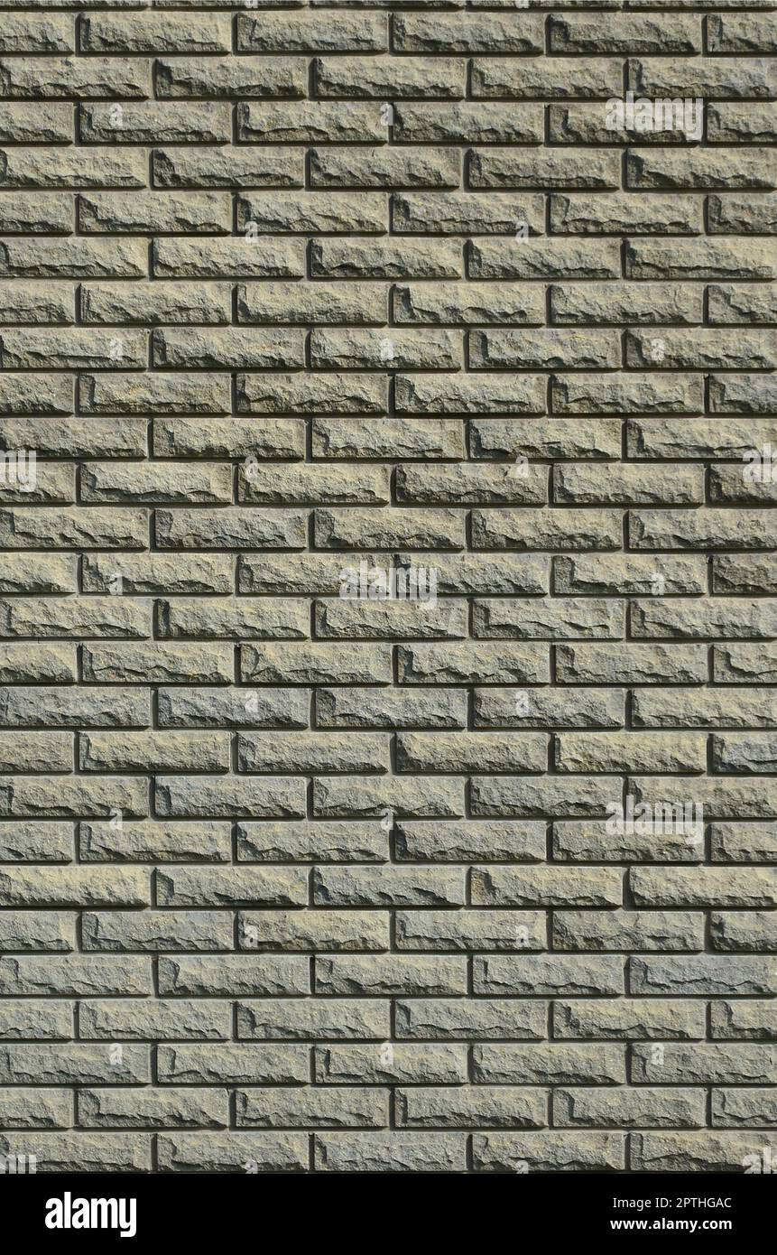 The texture of the wall is made of modern relief brown brick ...