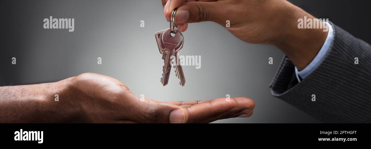 African Man Giving House Key. Receiving Real Estate Keys Stock Photo ...
