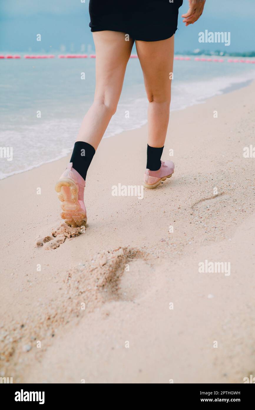 step of woman leg walking forward on sea beach Stock Photo - Alamy