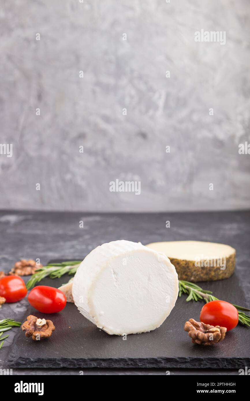 White goat cheese and various types of cheese with rosemary and ...