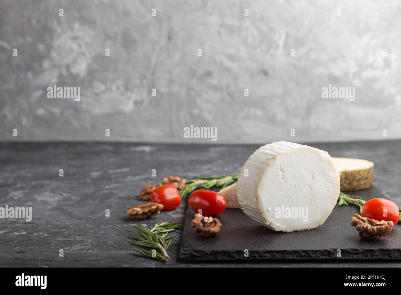 White goat cheese and various types of cheese with rosemary and ...