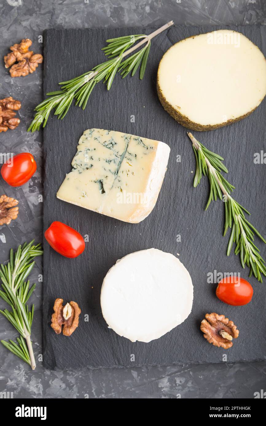 White goat cheese and various types of cheese with rosemary and ...