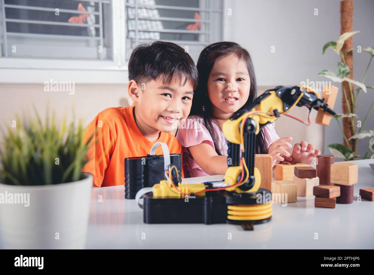 Two children programming and testing robot arm their science, Kid ...