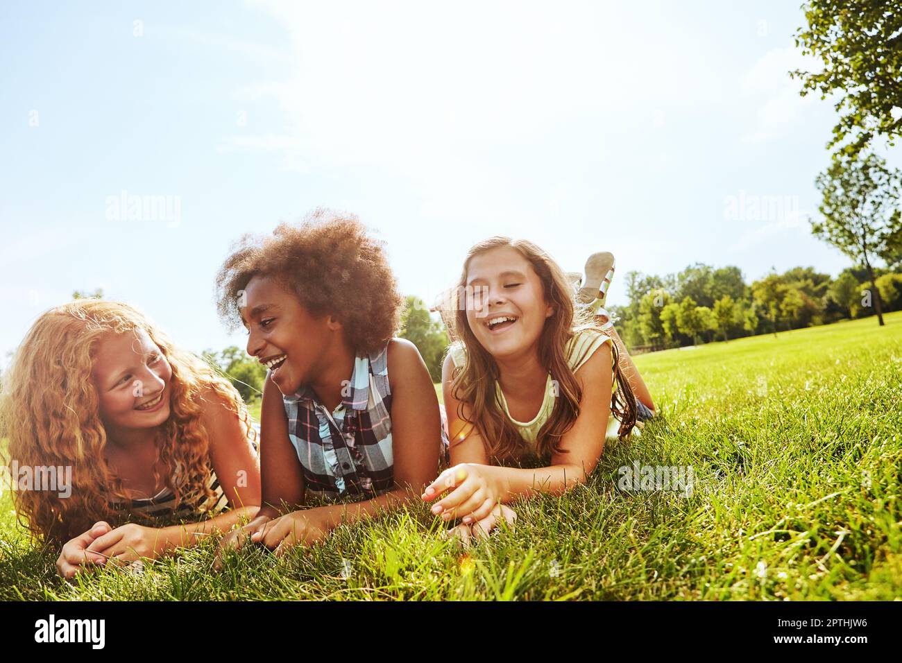 Theyve got all the jokes to tell. three young girls lying together on ...