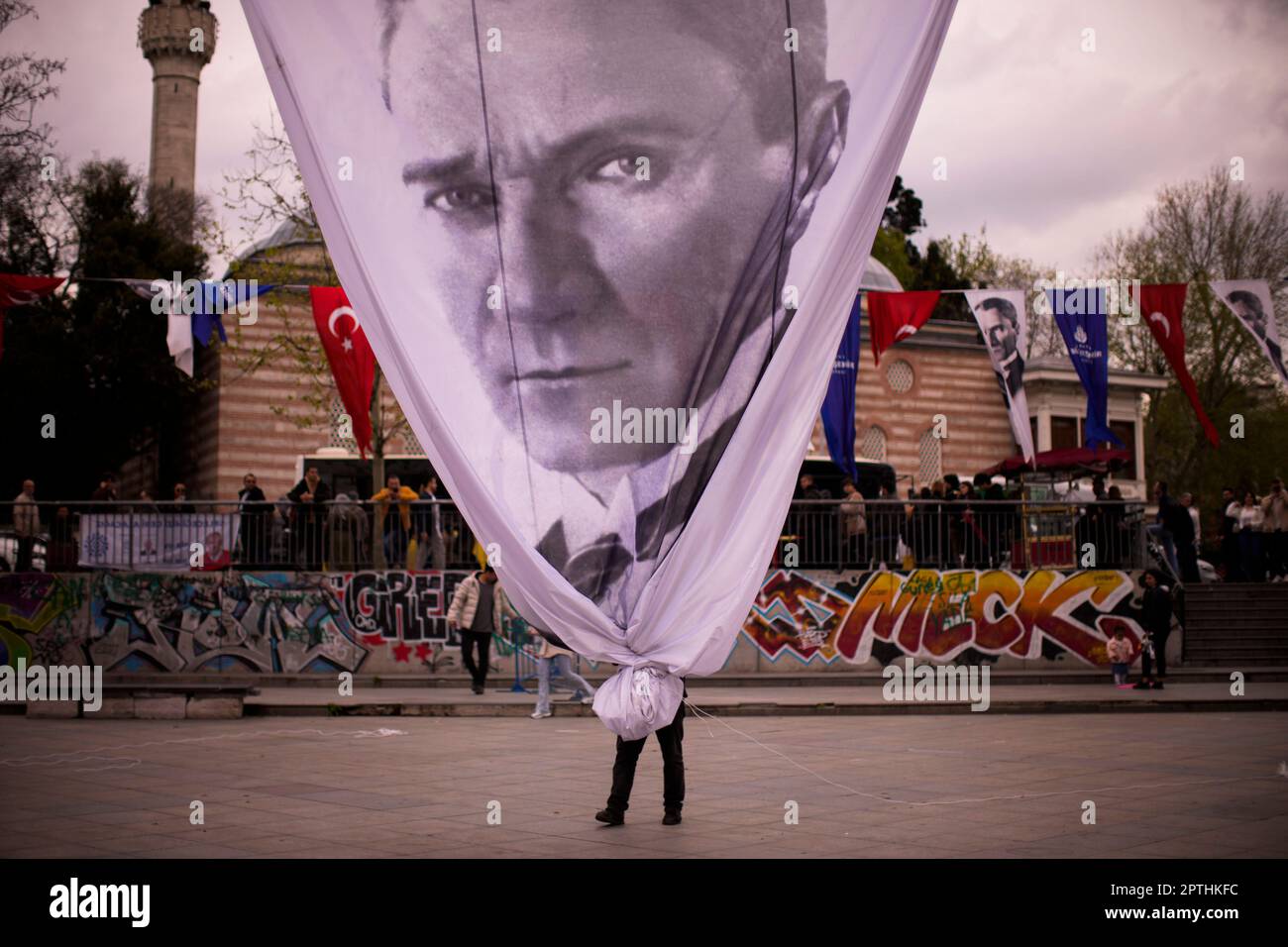 A worker removes a giant banner with the image of Mustafa Kemal Ataturk ...