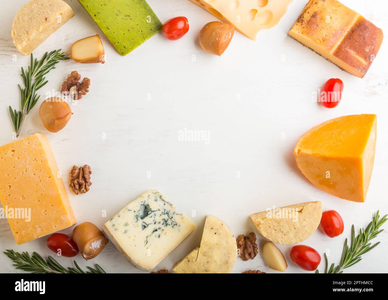 Set of different types of cheese with rosemary and tomatoes in the ...