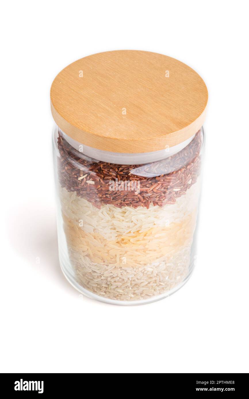 glass jar with different kinds of rice poured in layers isolated on ...