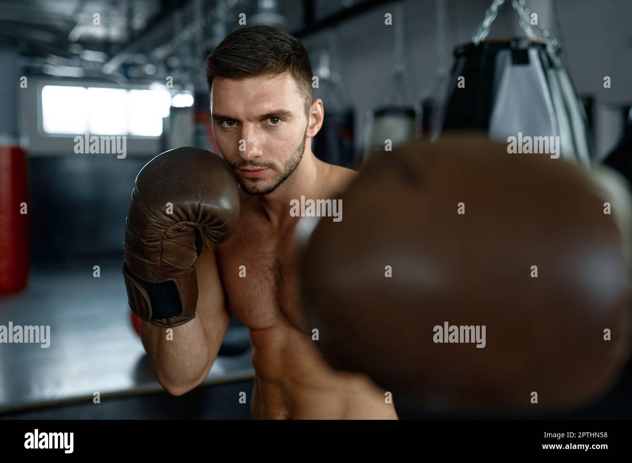 Confidence man boxer do sport training boxing exercise punching air in ...