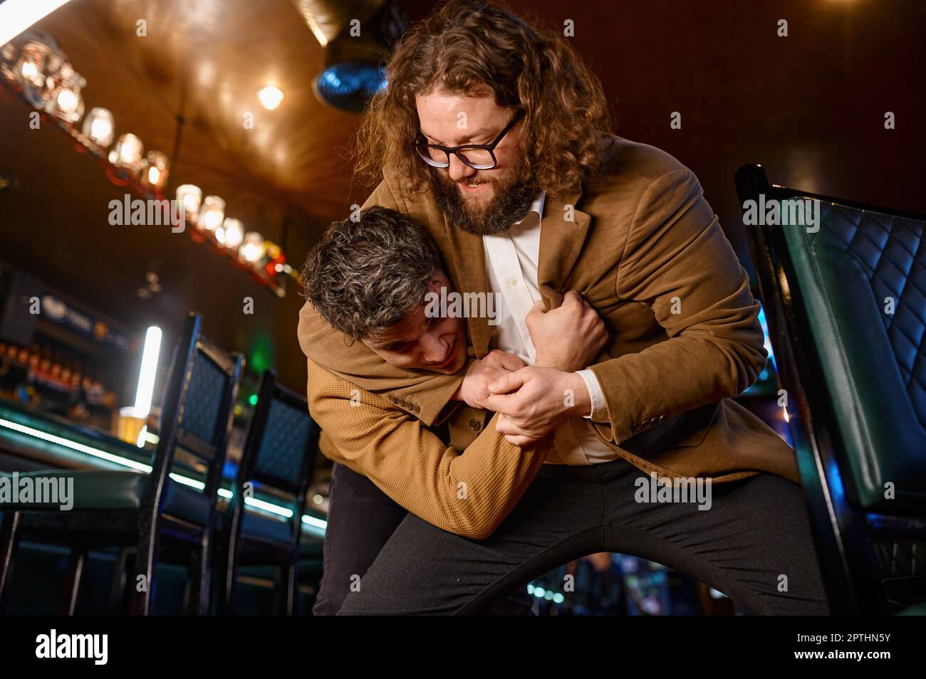 Two men fighting at sport bar for their favorite football team. Drunk ...