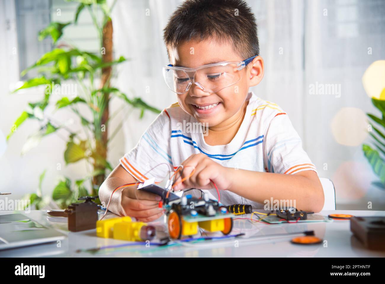 Little child remotely learn online with car toy before sent code, Asian ...