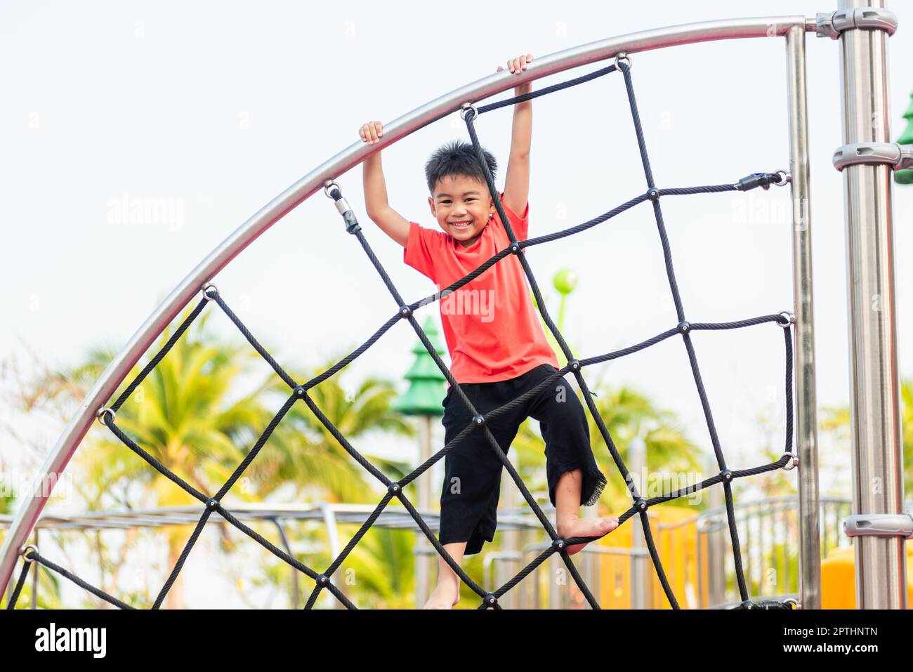 Asian child smiling playing climbing outdoor playground, happy ...
