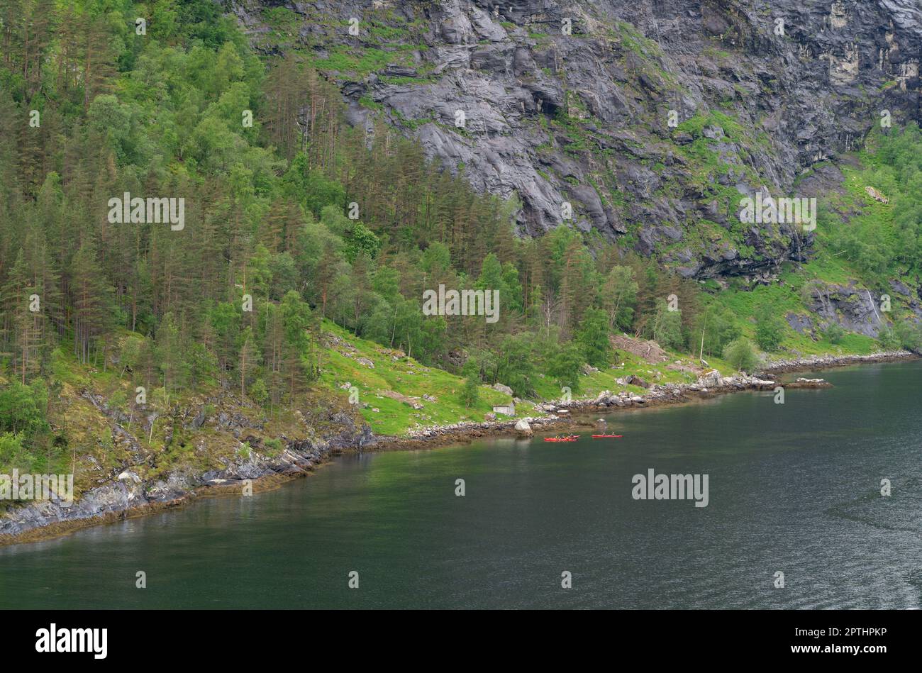 Beautiful Geiranger Fjord in Norway with on which people paddle in two ...