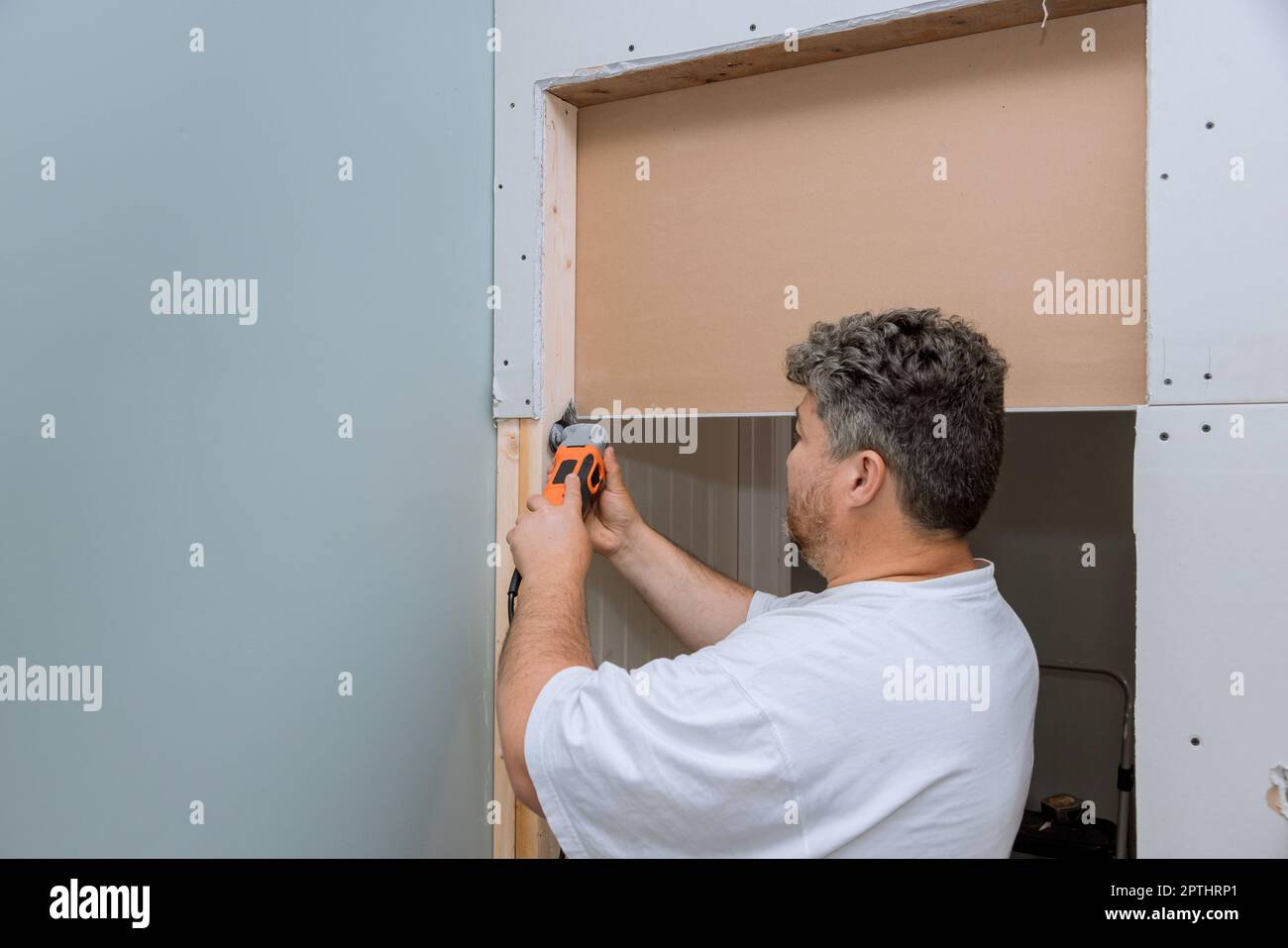 Worker cuts drywall plasterboard with help of multi tool Stock Photo ...