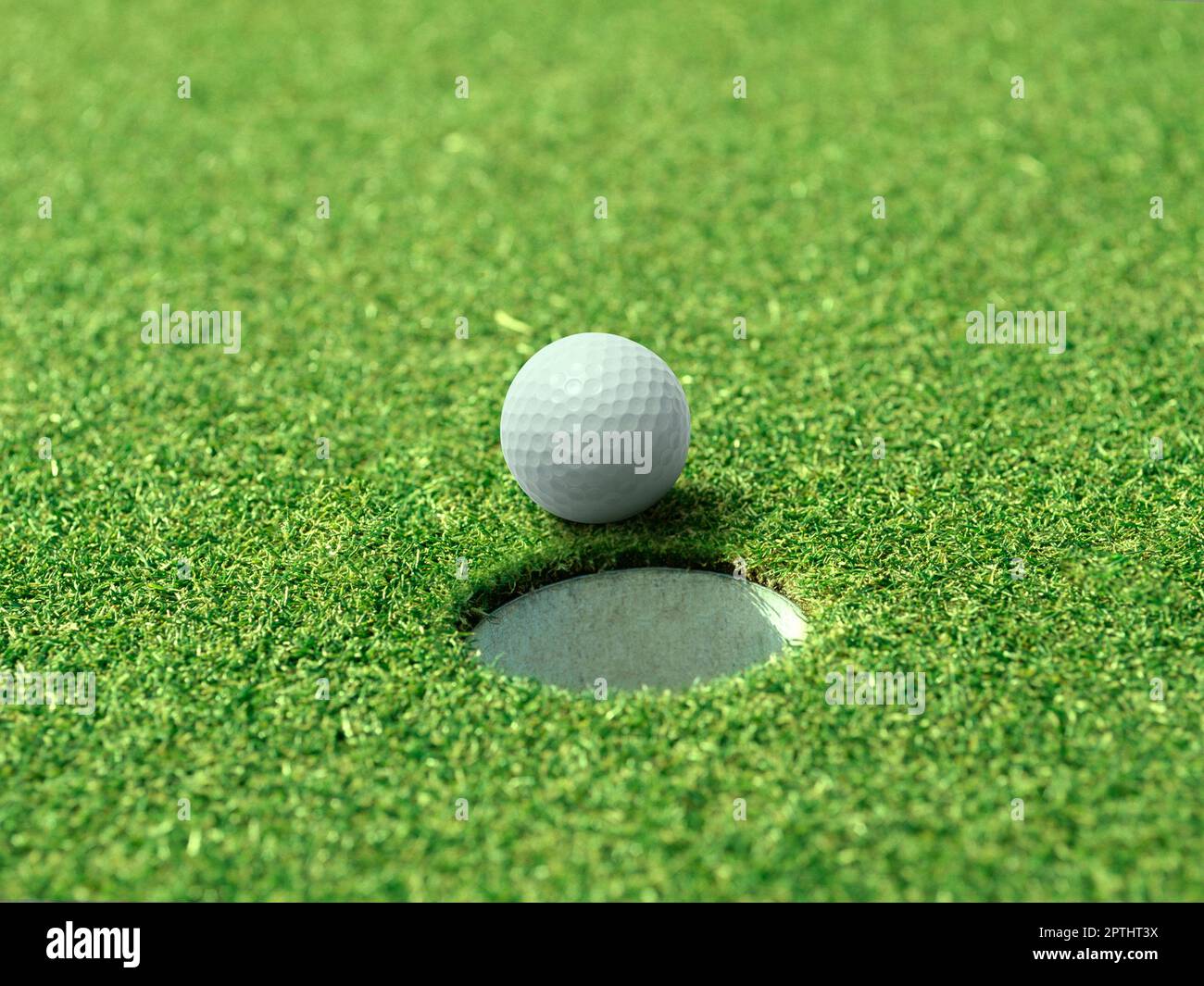 golf ball on lip of cup of lovely beautiful golf course Stock Photo - Alamy