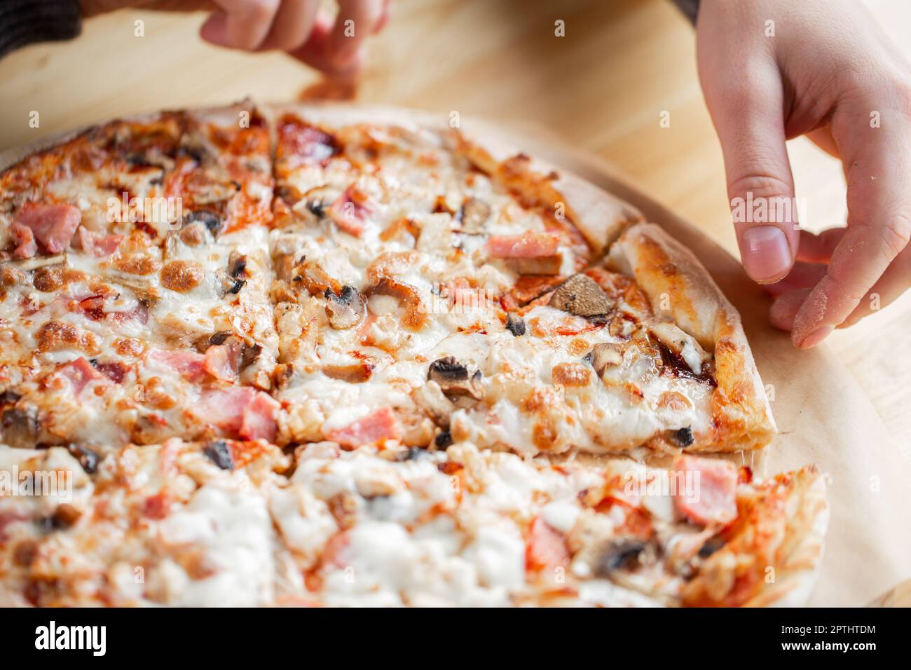 one people taking slices of pizza out of the box. fast delivery of food ...