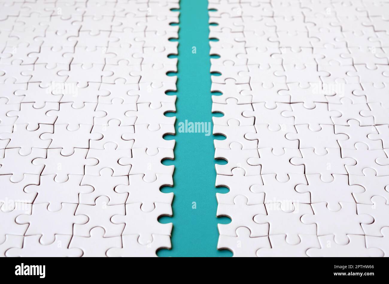 The blue path is laid on the platform of a white folded jigsaw puzzle ...