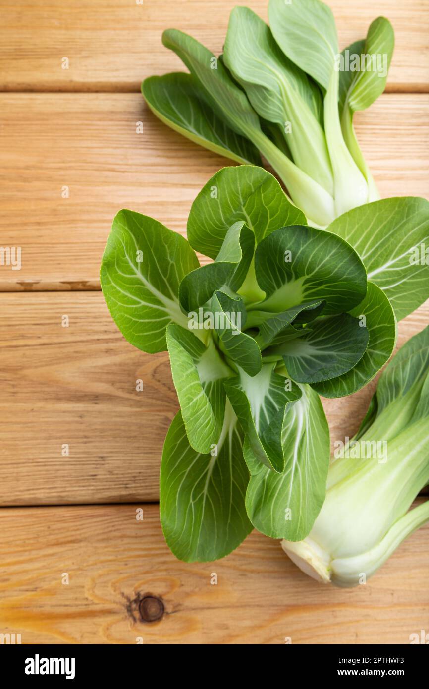 Fresh green bok choy or pac choi chinese cabbage on a brown wooden ...