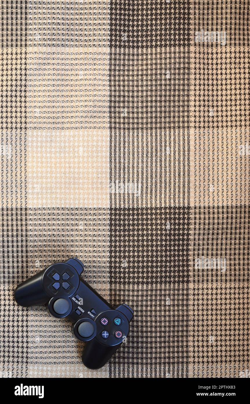 Close-up photo of a black plastic wireless game controller on a ...