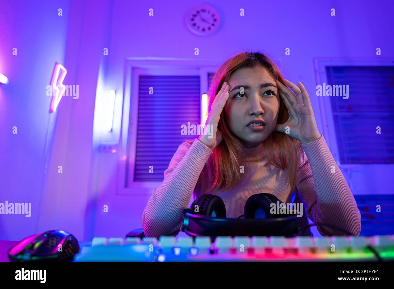 Game Over. Asian gamer playing online video game she losing and sad on ...