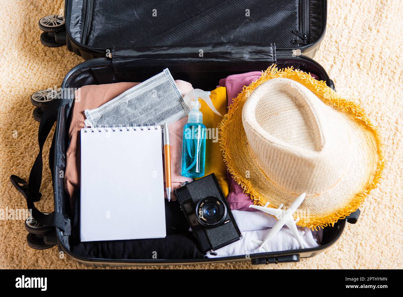 Open suitcase with traveler belongings clothes and accessories of ...