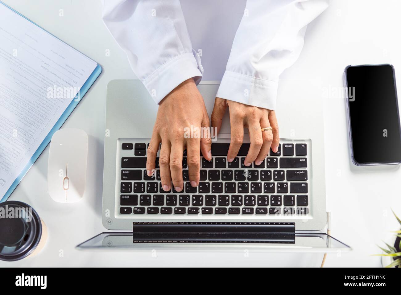 Hands of female doctor wear uniform in hospital she typing information ...