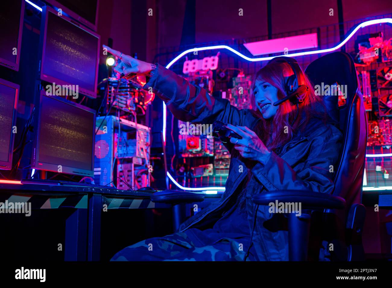 Woman wear gaming headphones playing esports games console gaming room ...