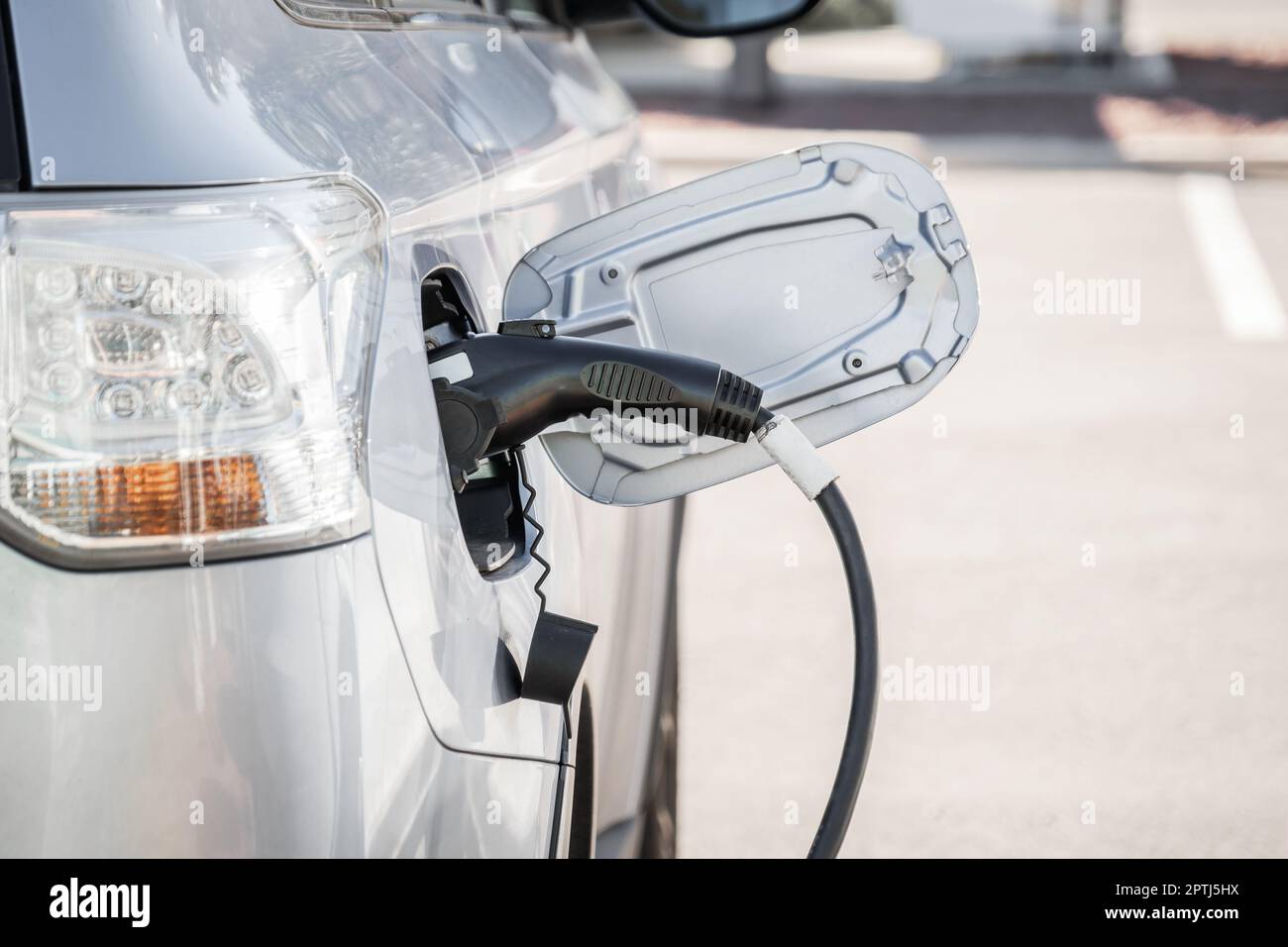 Electric car connected to EV charging station with EV charging cable ...