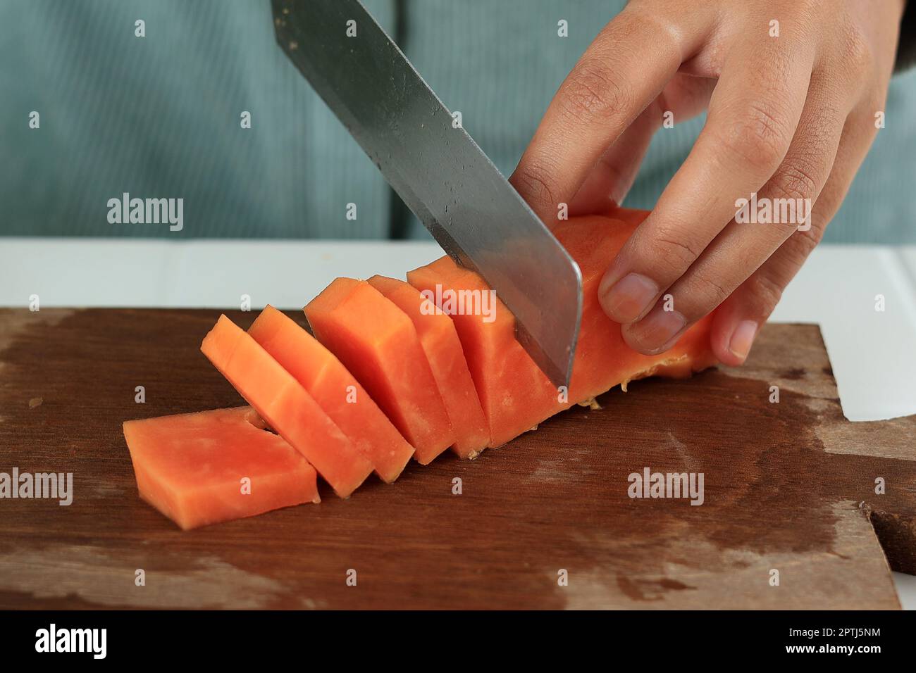 Cutting or Slicing Peeled Ripe Papaya on Wooden Chopping Board, Female ...