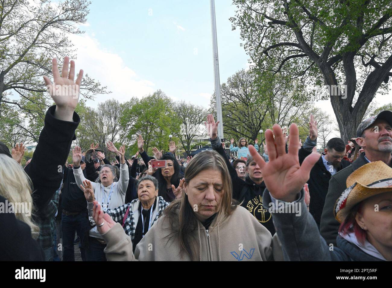 TOPEKA, KANSAS - APRIL 23, 2023 Crowd of worshippers raise their hand ...