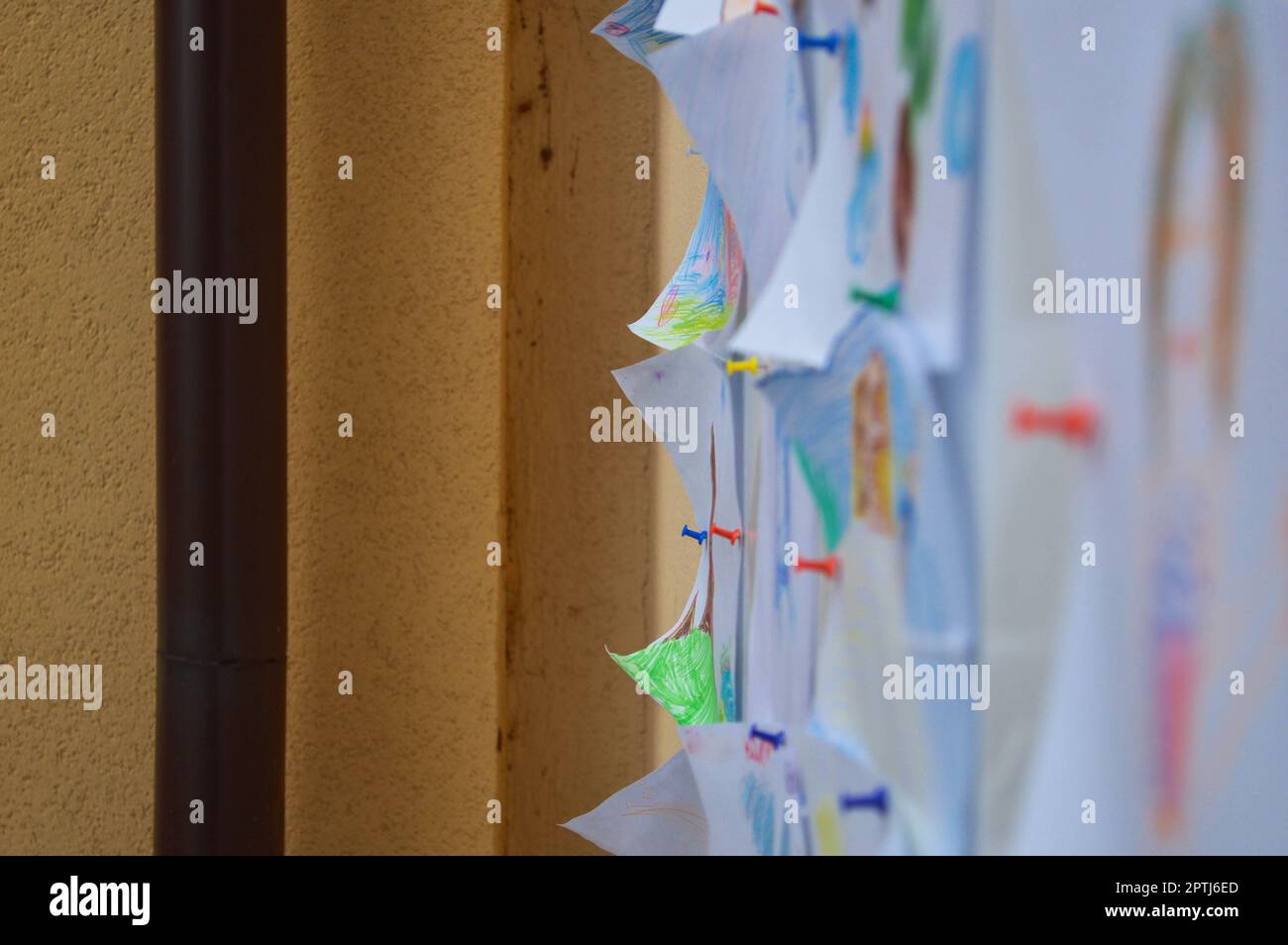 Sheets of paper, notes, drawings, documents pinned to a blackboard, a ...